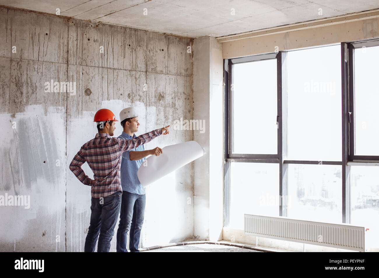 architector is talking with investor and pointing at the outdoors in ...