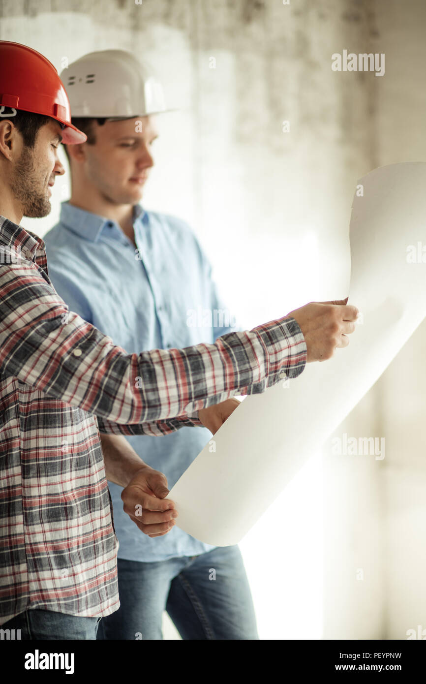 two colleagues are solving problems at workplace. close up side view ...