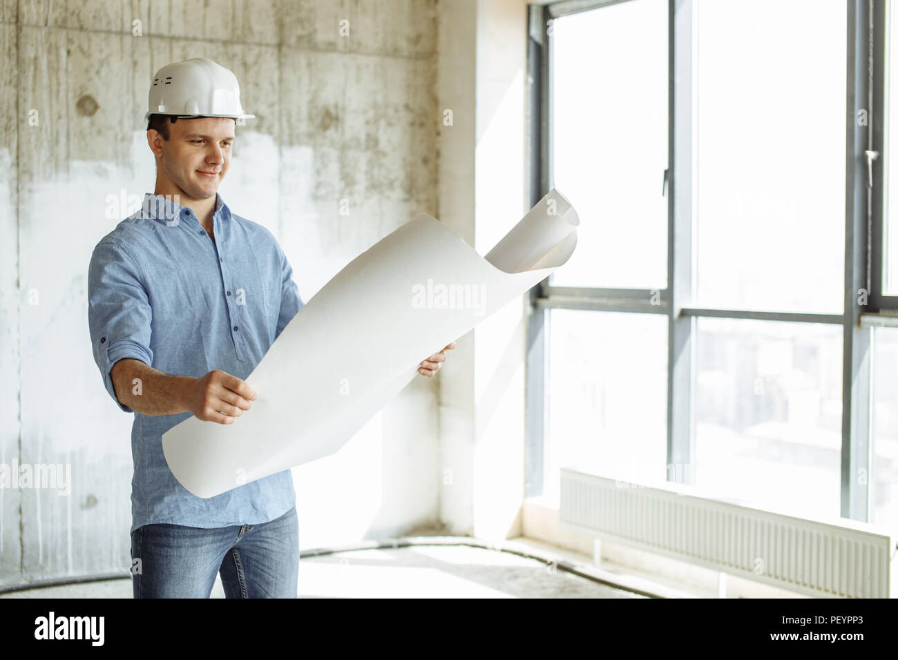 cheerful, handsome, smiling, successful architect has finished his ...