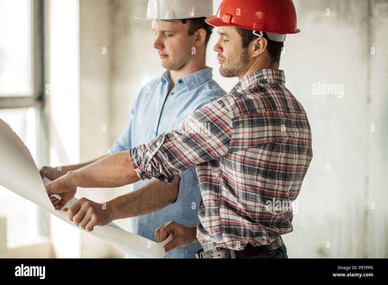 two engineers are making up the project at workplace.social service ...