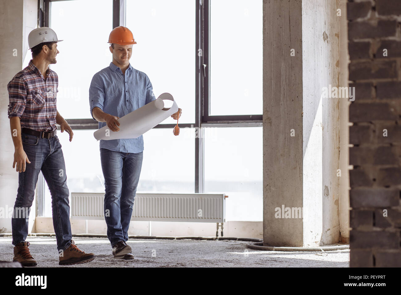 positive workers are making up a design and development of a new office ...