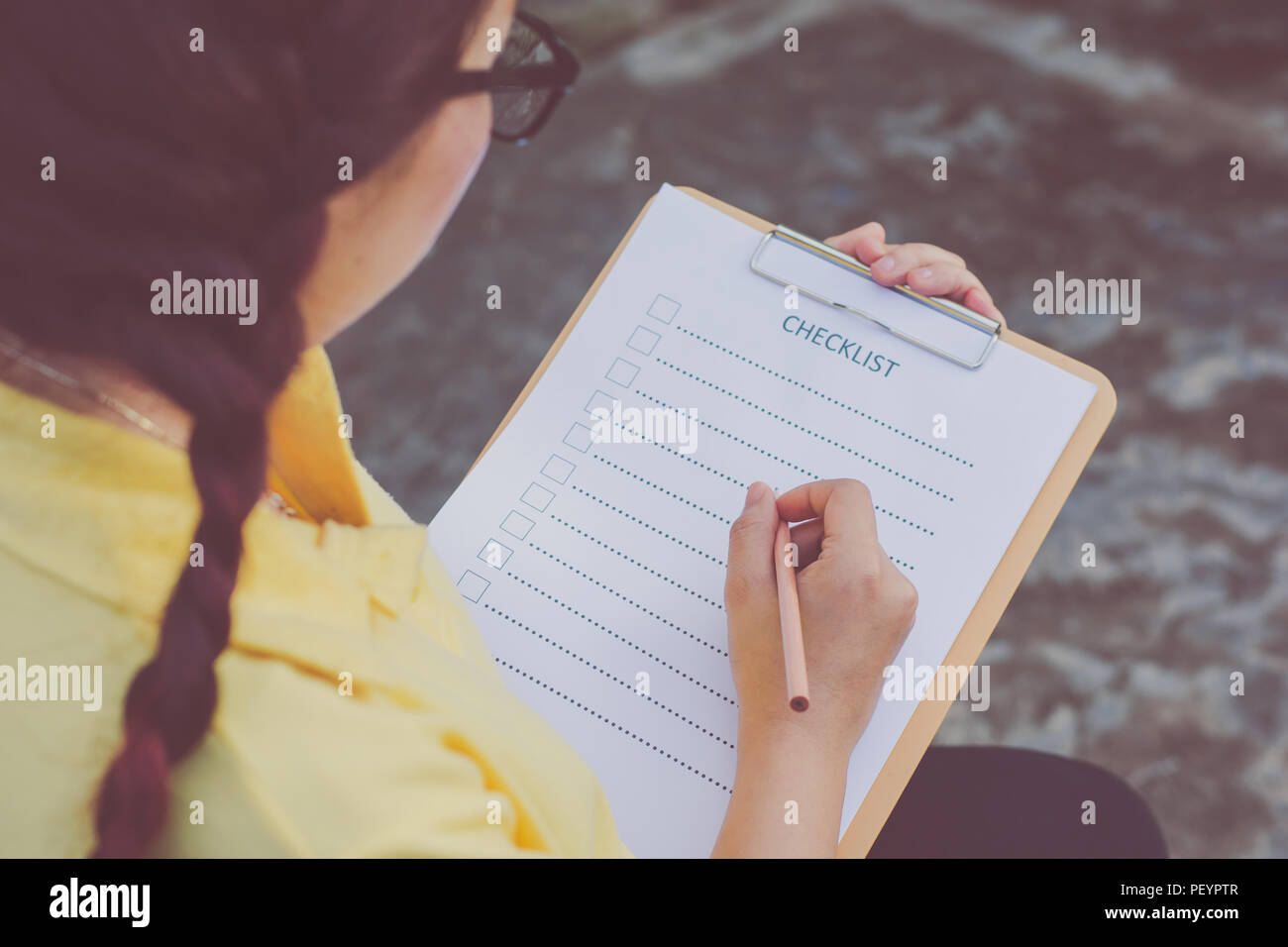 business female preparing checklist at office desk Stock Photo - Alamy
