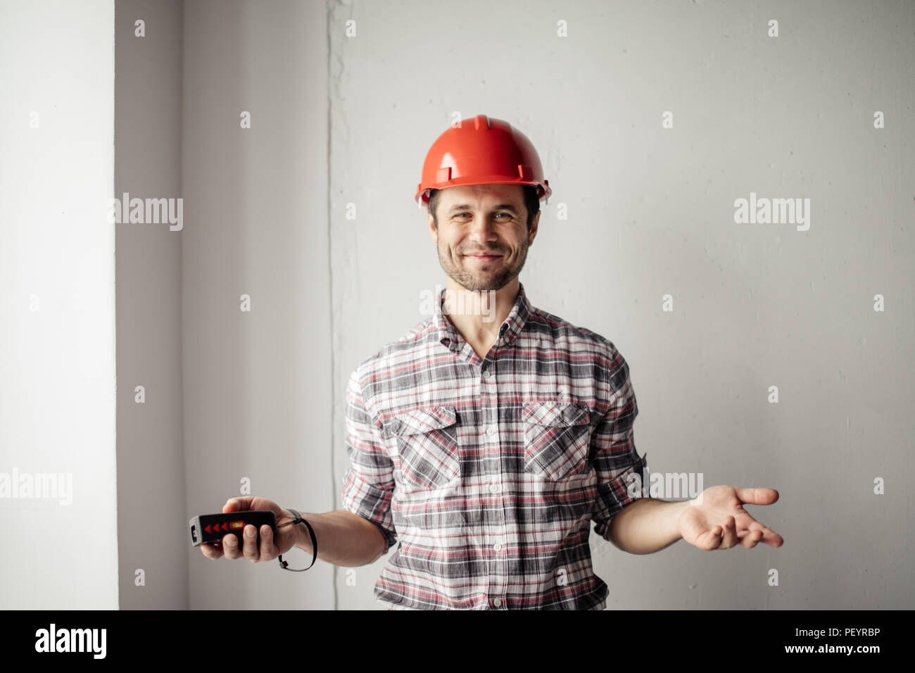 positive builder with tool in hands greeting his in the construction ...
