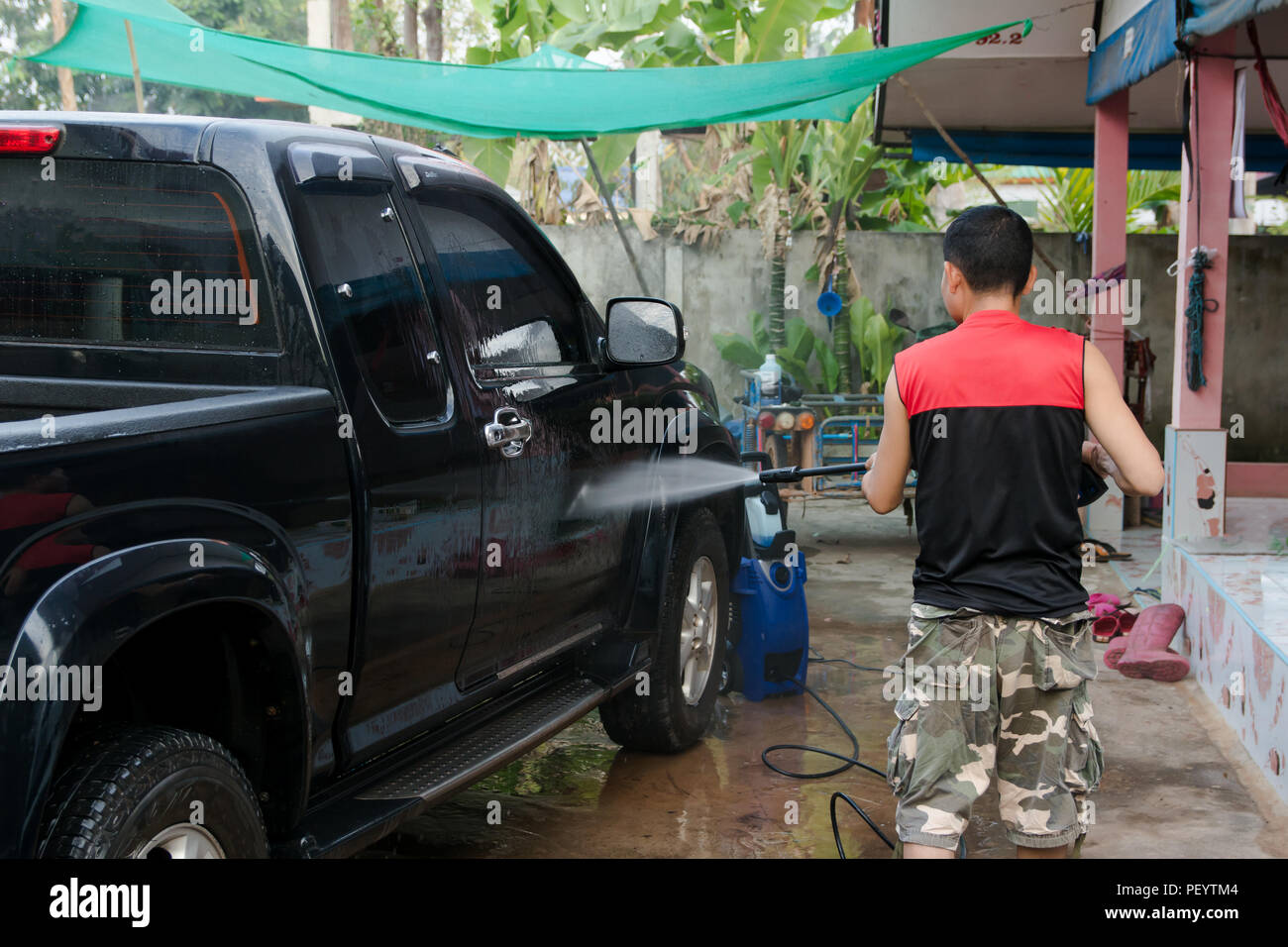 Man washing black pickup truck car with high pressure washer Stock ...