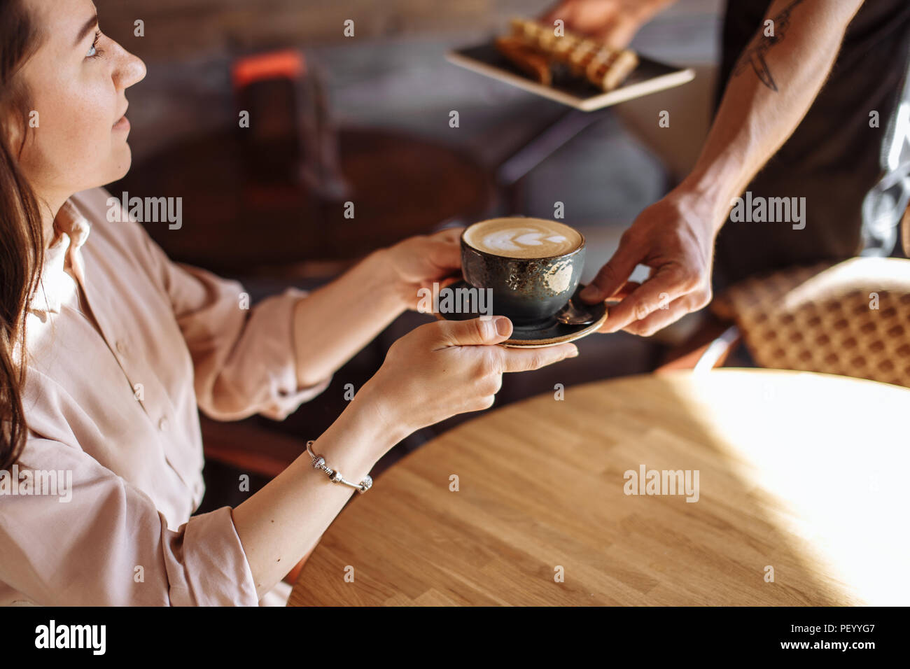 nice woman is thanking a waiter for a cup of latte Stock Photo - Alamy