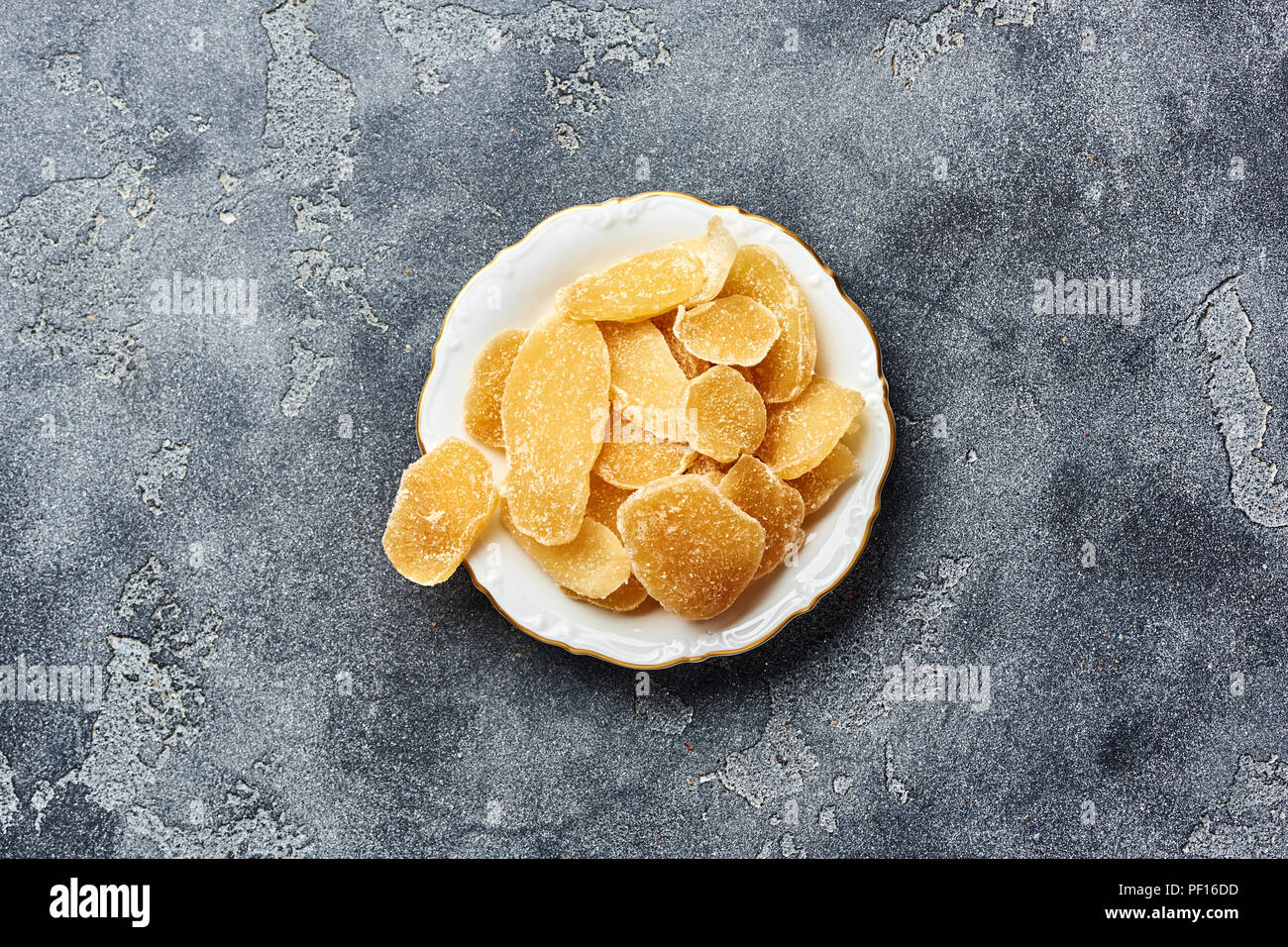 Dried sweet ginger with sugar on a gray table. Top view Stock Photo - Alamy