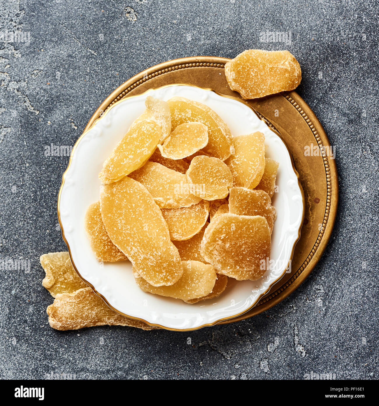 Dried sweet ginger with sugar on a gray table. Top view Stock Photo - Alamy