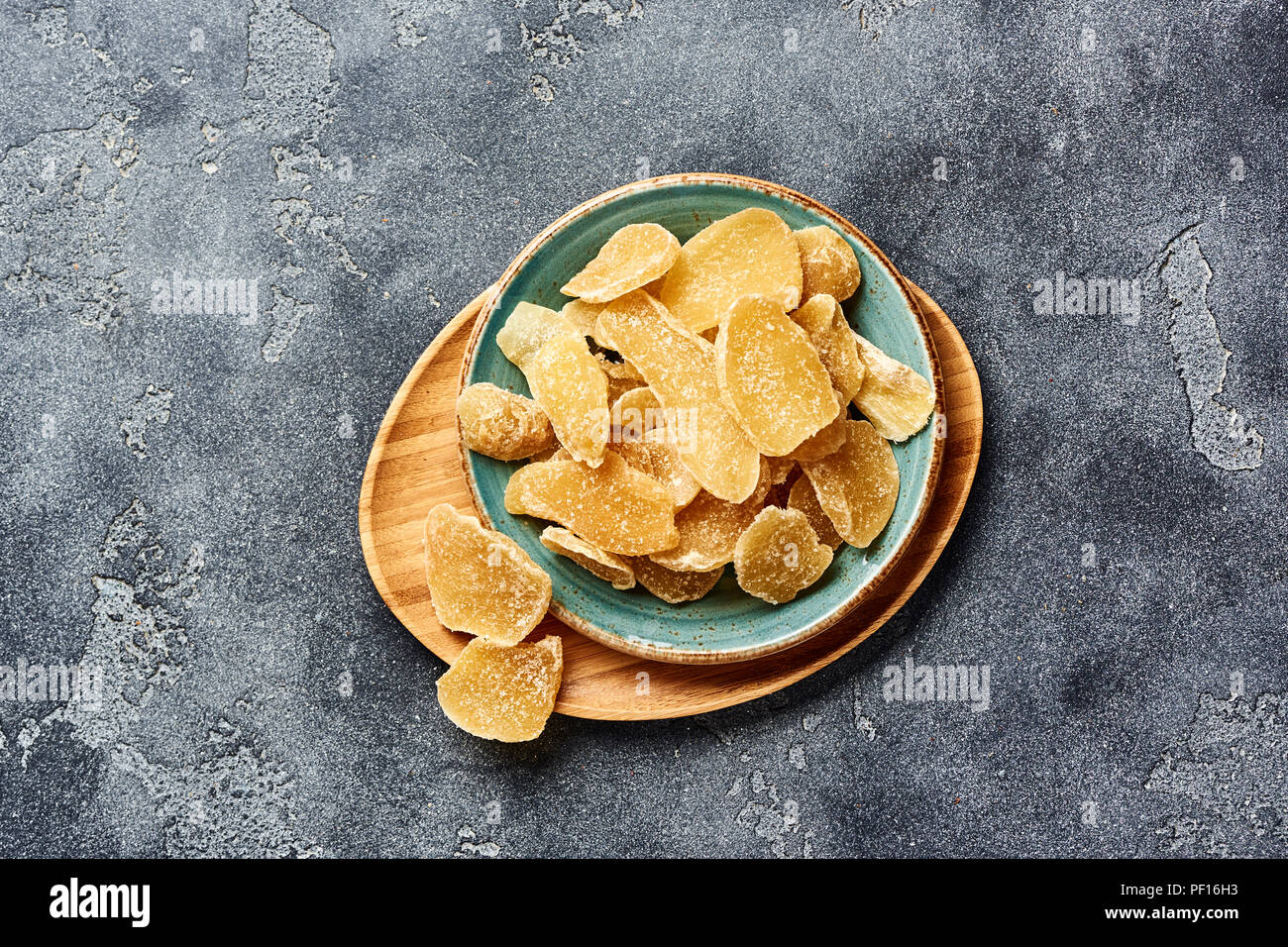 Dried sweet ginger with sugar on a gray table. Top view Stock Photo - Alamy