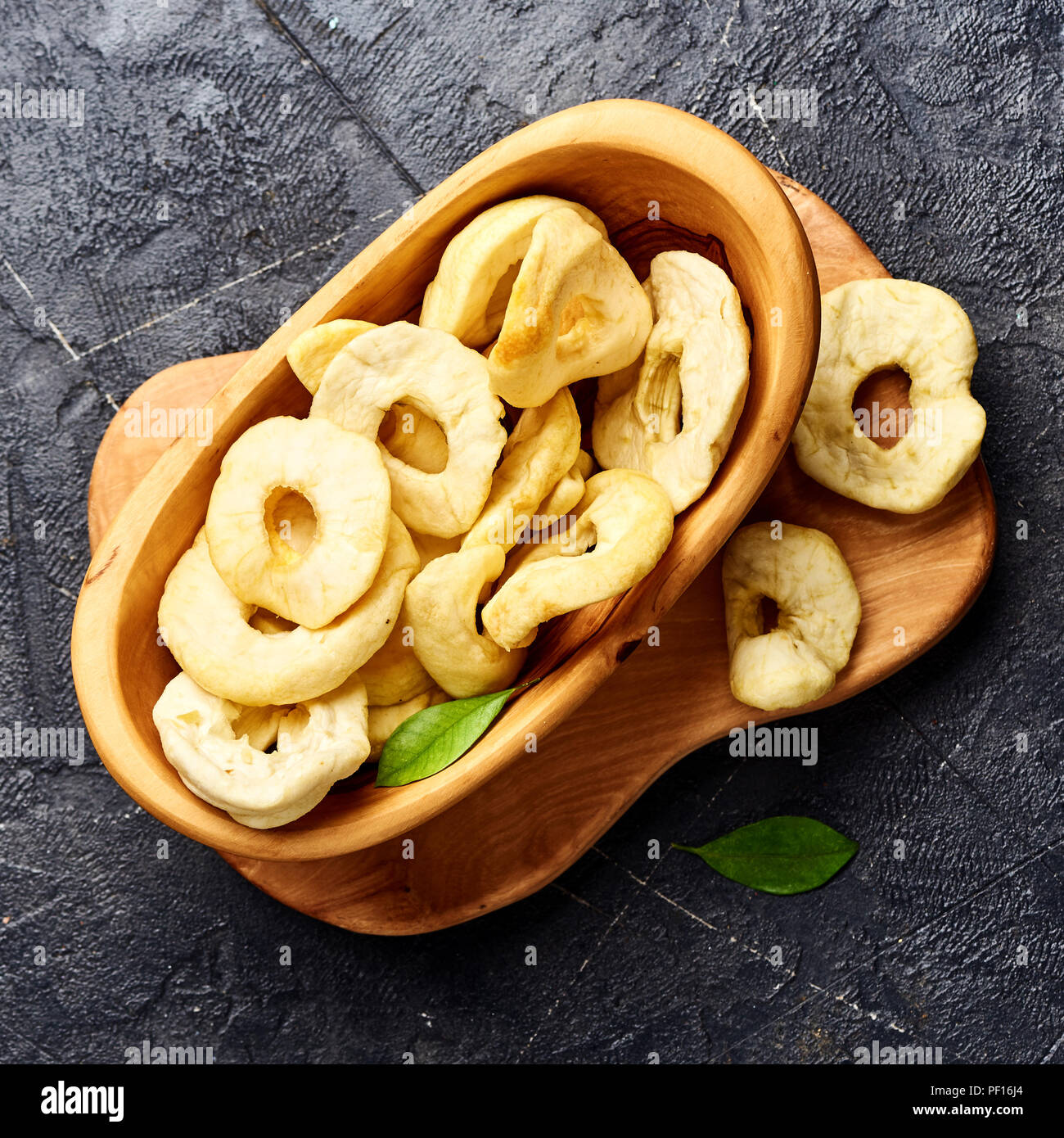 Dried apple rings on black background. Top view Stock Photo - Alamy