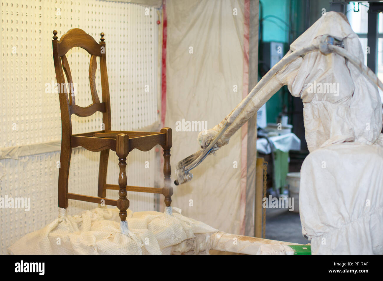 Furniture factory. Robot machine lacquer chair.Making chairs in the ...