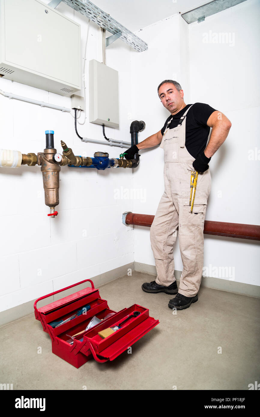Plumber repairing metallic water pipes with wrench Stock Photo - Alamy