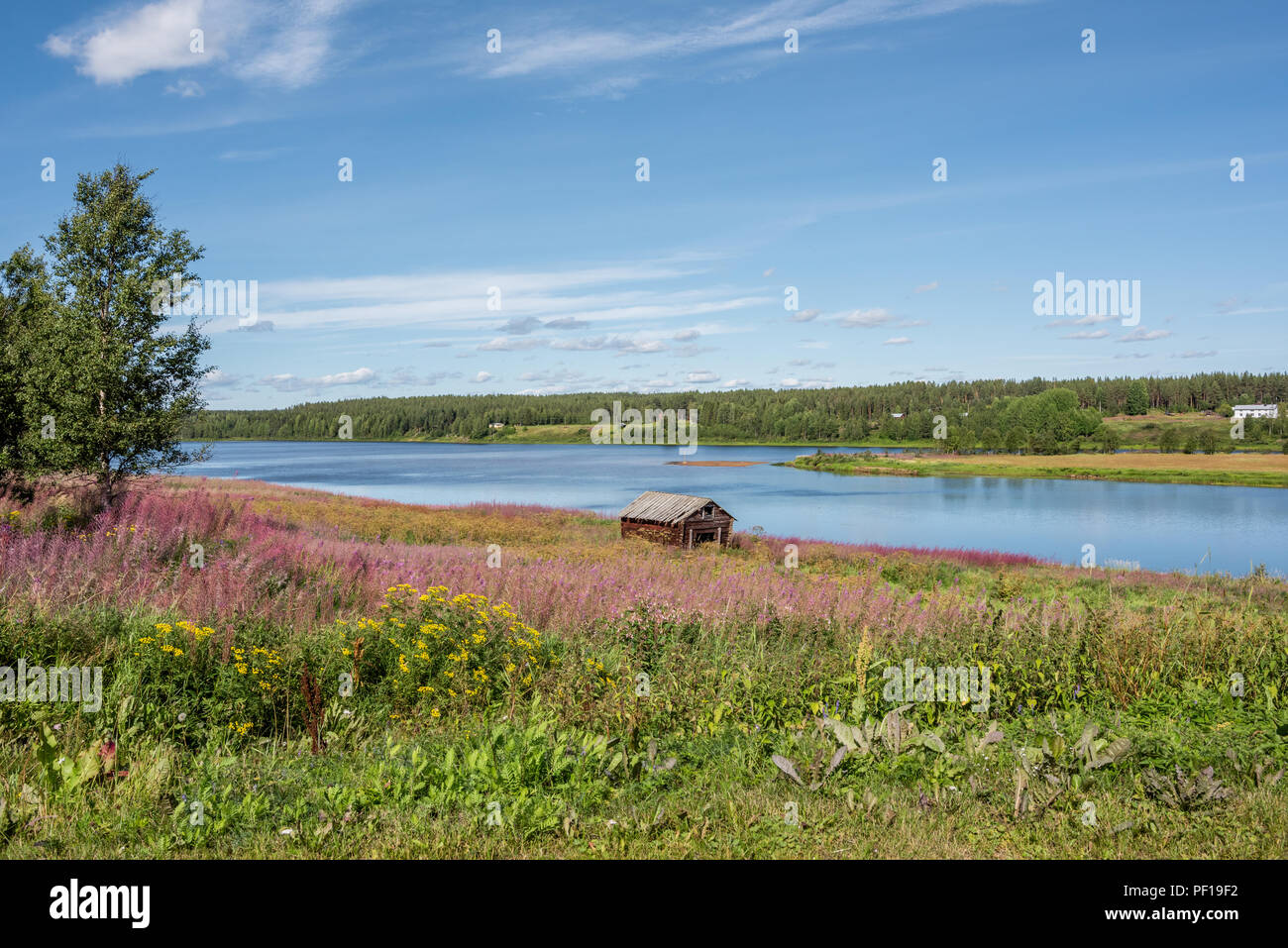 View from Pajala in northern Sweden across Torne river on a sunny ...