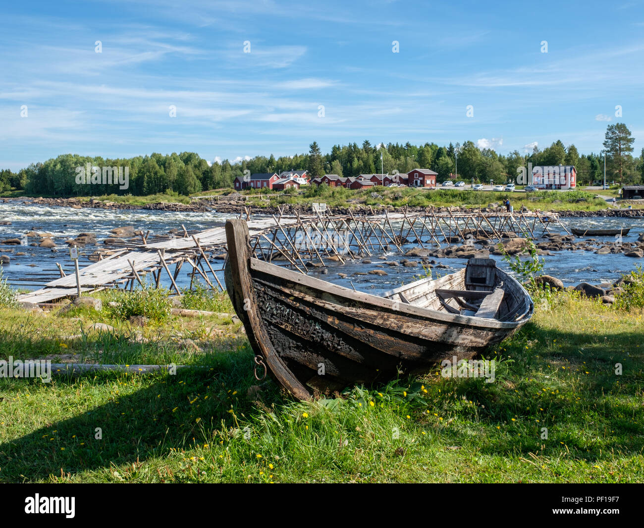 Traditional rowboat and view from the Swedish side of Kukkola rapids ...