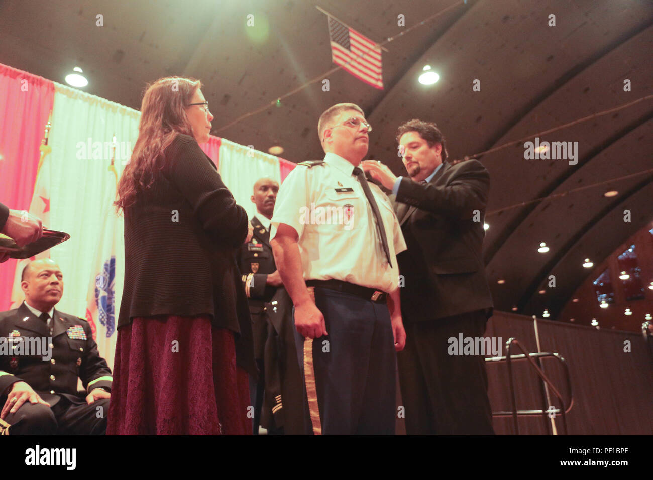 Siblings attach new epaulettes onto the dress shirt of Chaplain (Lt ...