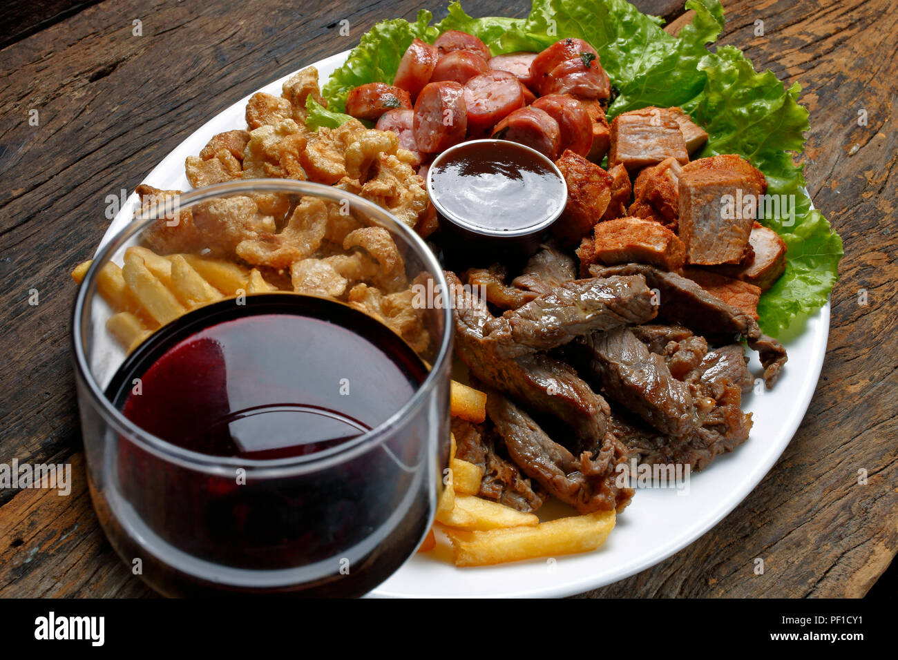 Snacks with fries, crackers, meat, pork, sausage, babercue sauce and ...