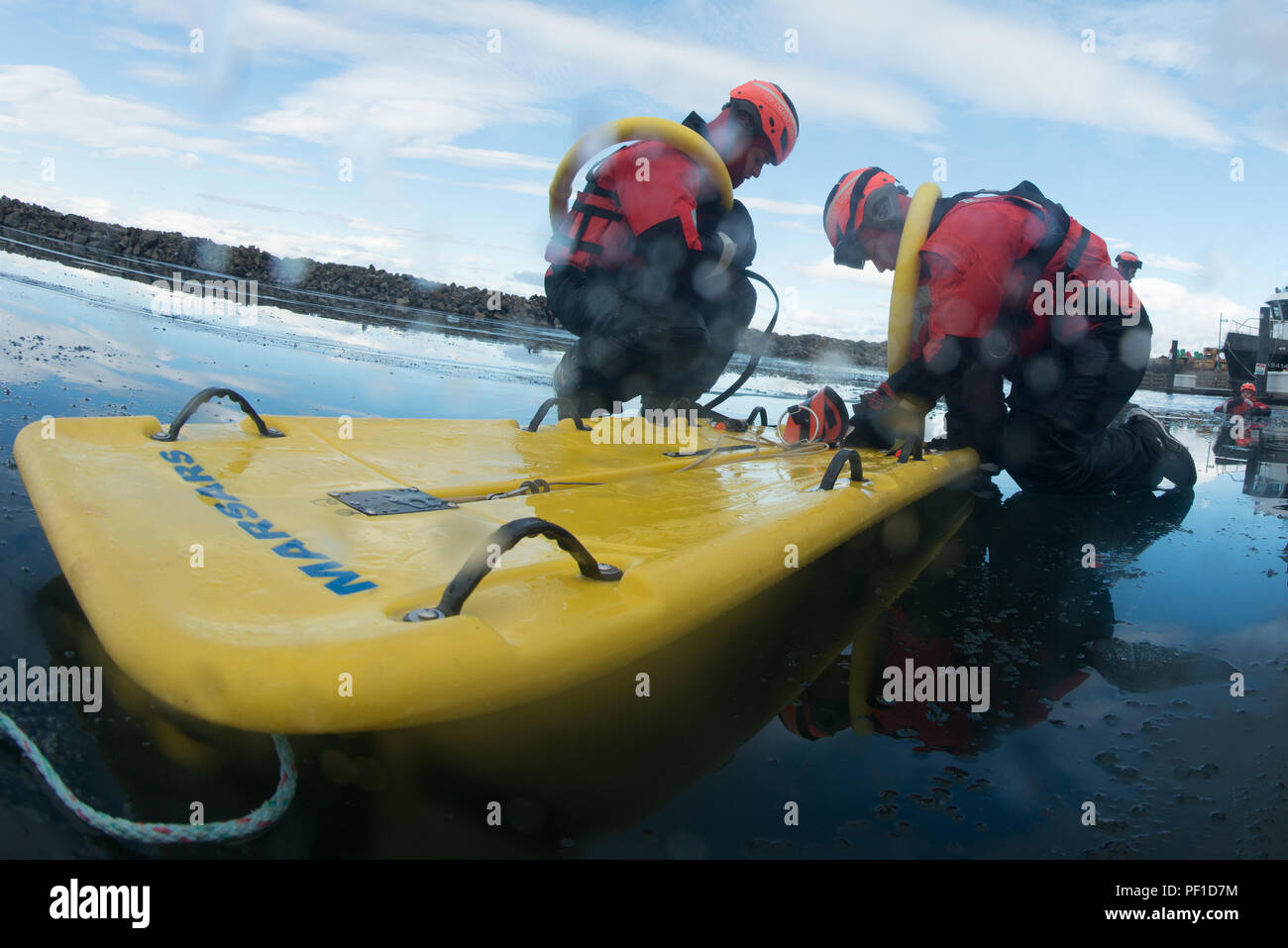 Members of Station Burlington, Vermont’s ice rescue team adjust straps ...