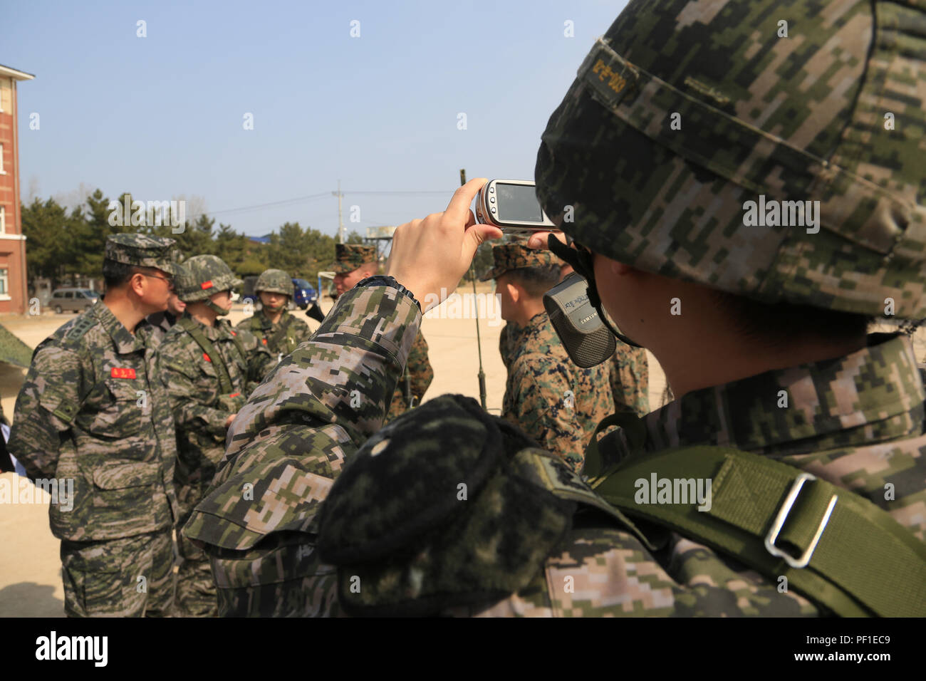 A Republic of Korea (ROK) Marine takes photographs of the U.S. Marines ...