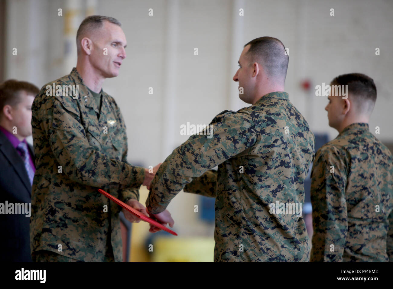 Maj. Gen. Gary L. Thomas congratulates and hands Sgt. Eric Foldvary a ...