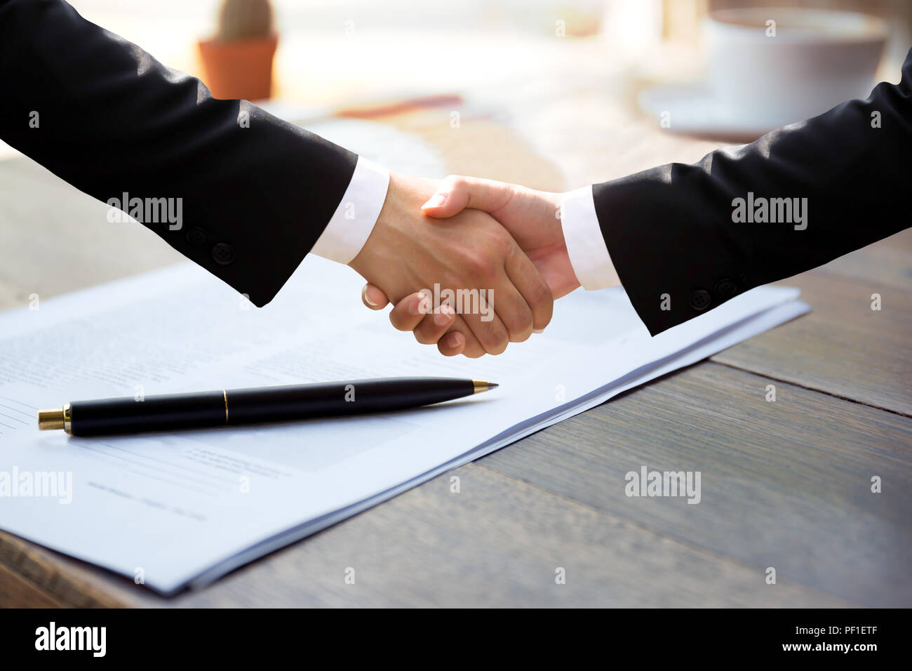 Business successful hand shaking hands over agreement form Stock Photo ...