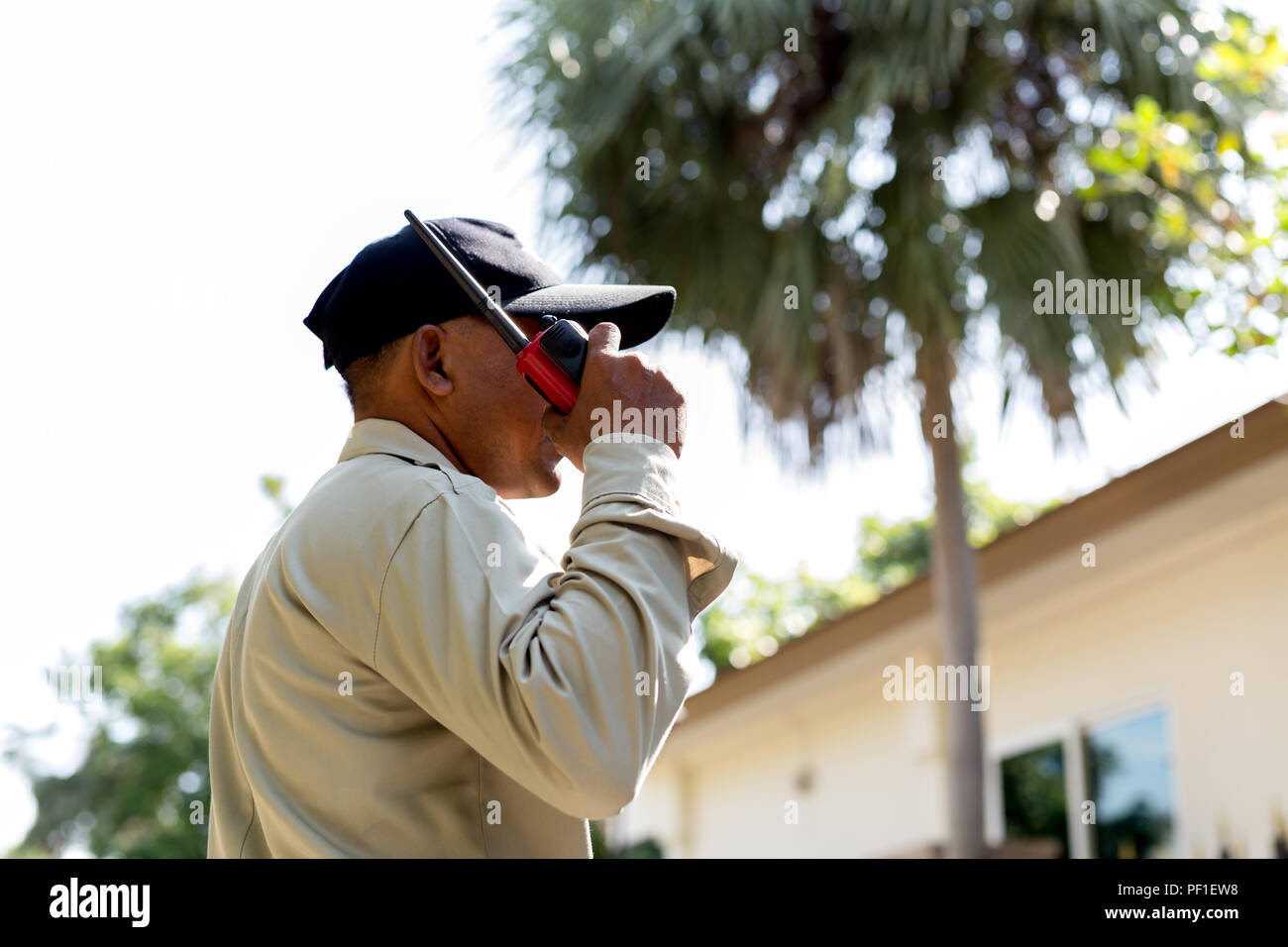 Male Security Guard talking on portable radio in village Stock Photo ...