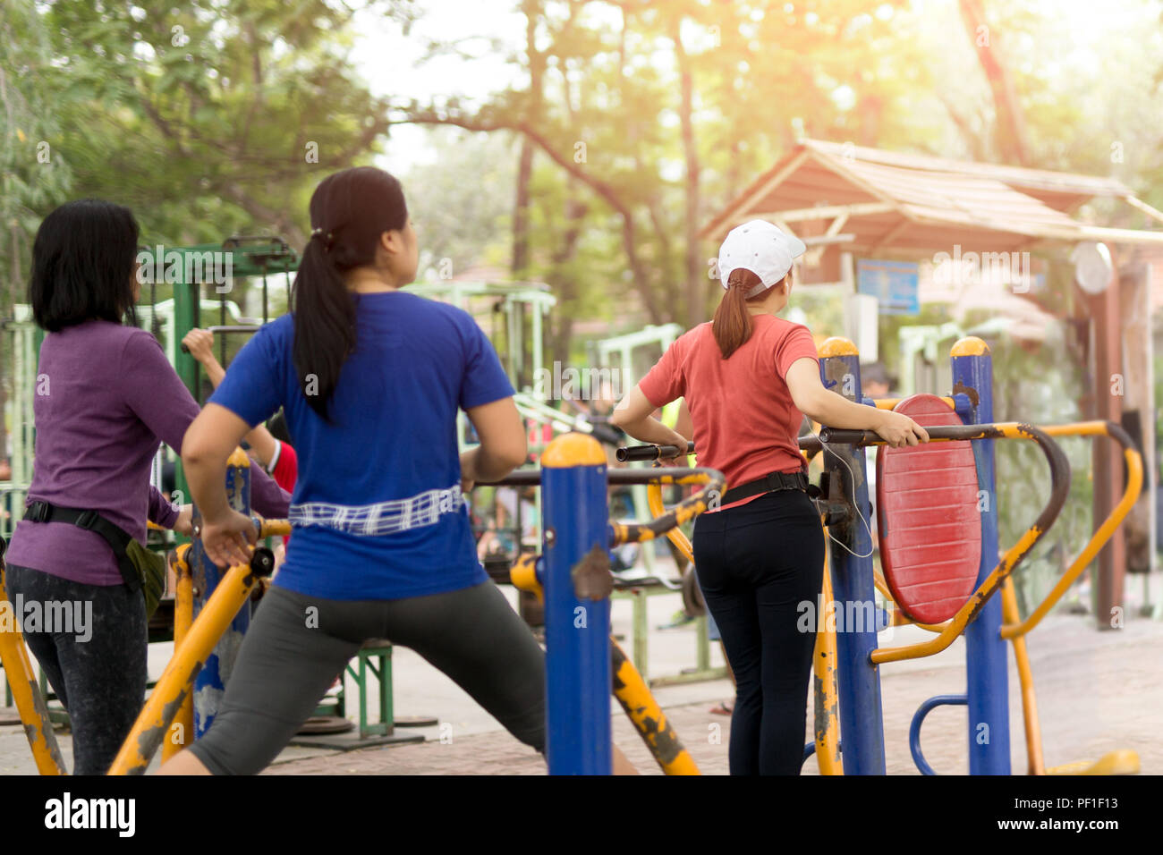 Woman exercise in the park with exercise equipment Stock Photo - Alamy