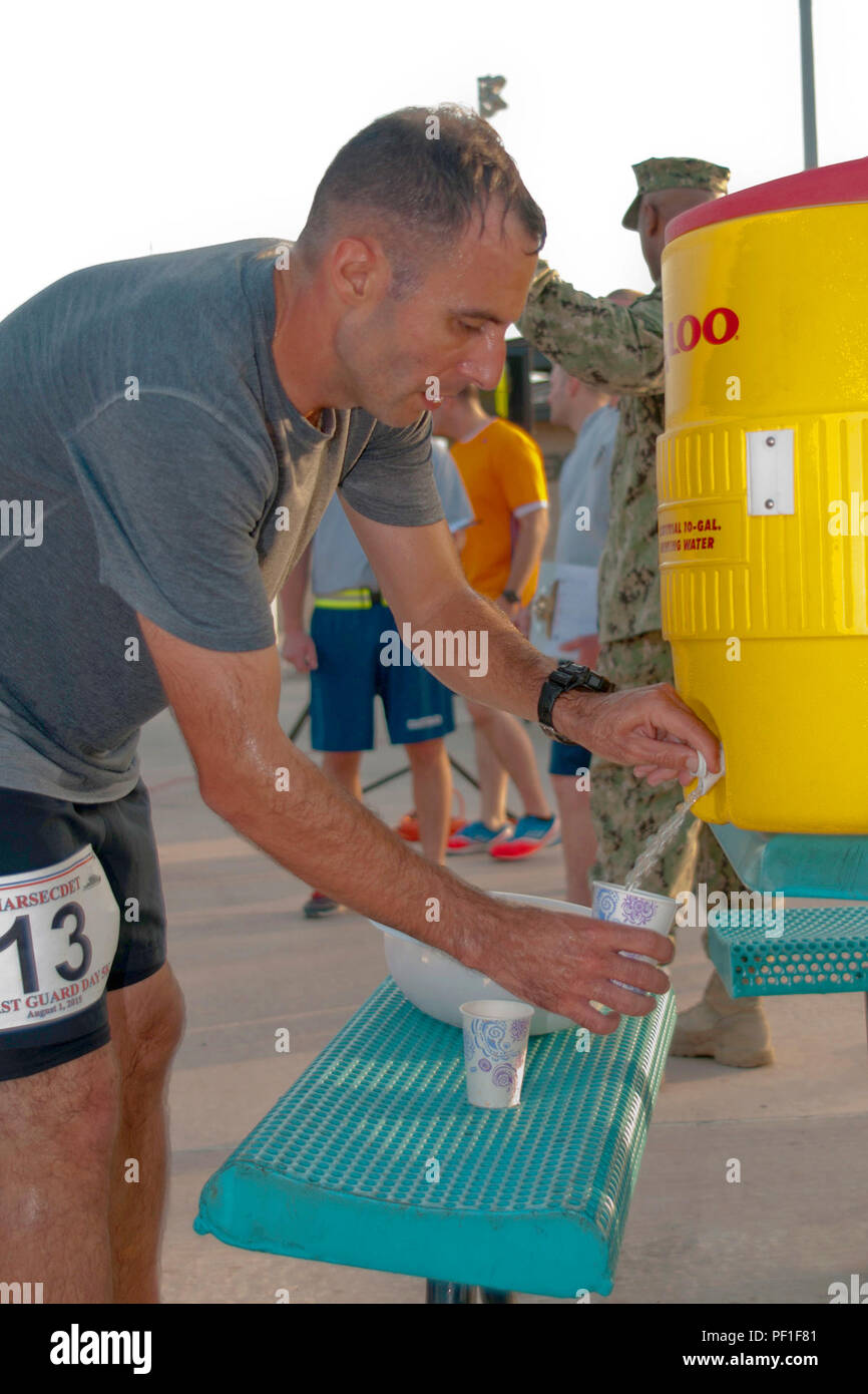 After crossing the finish line first, Michael Molina gets a drink of ...