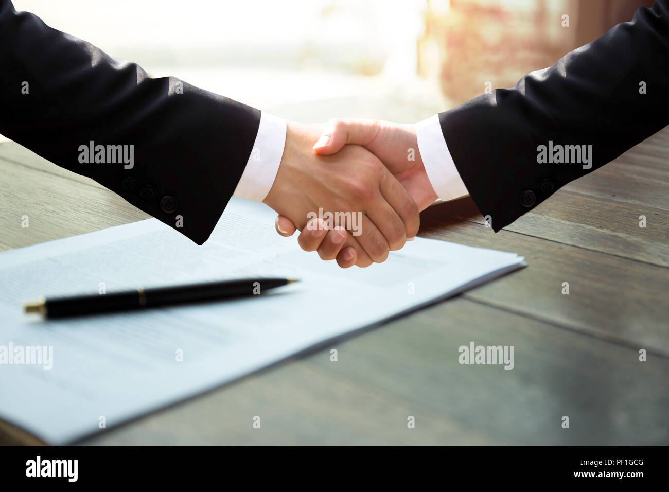 Business successful hand shaking hands over agreement form Stock Photo ...