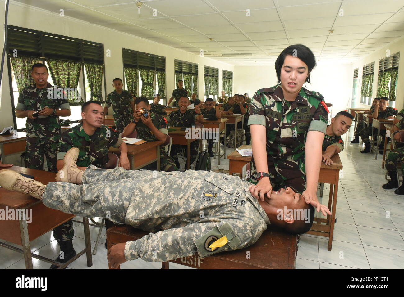 Indonesian Soldier Second Sgt. Dara Indah demonstrates with Sgt. 1st ...