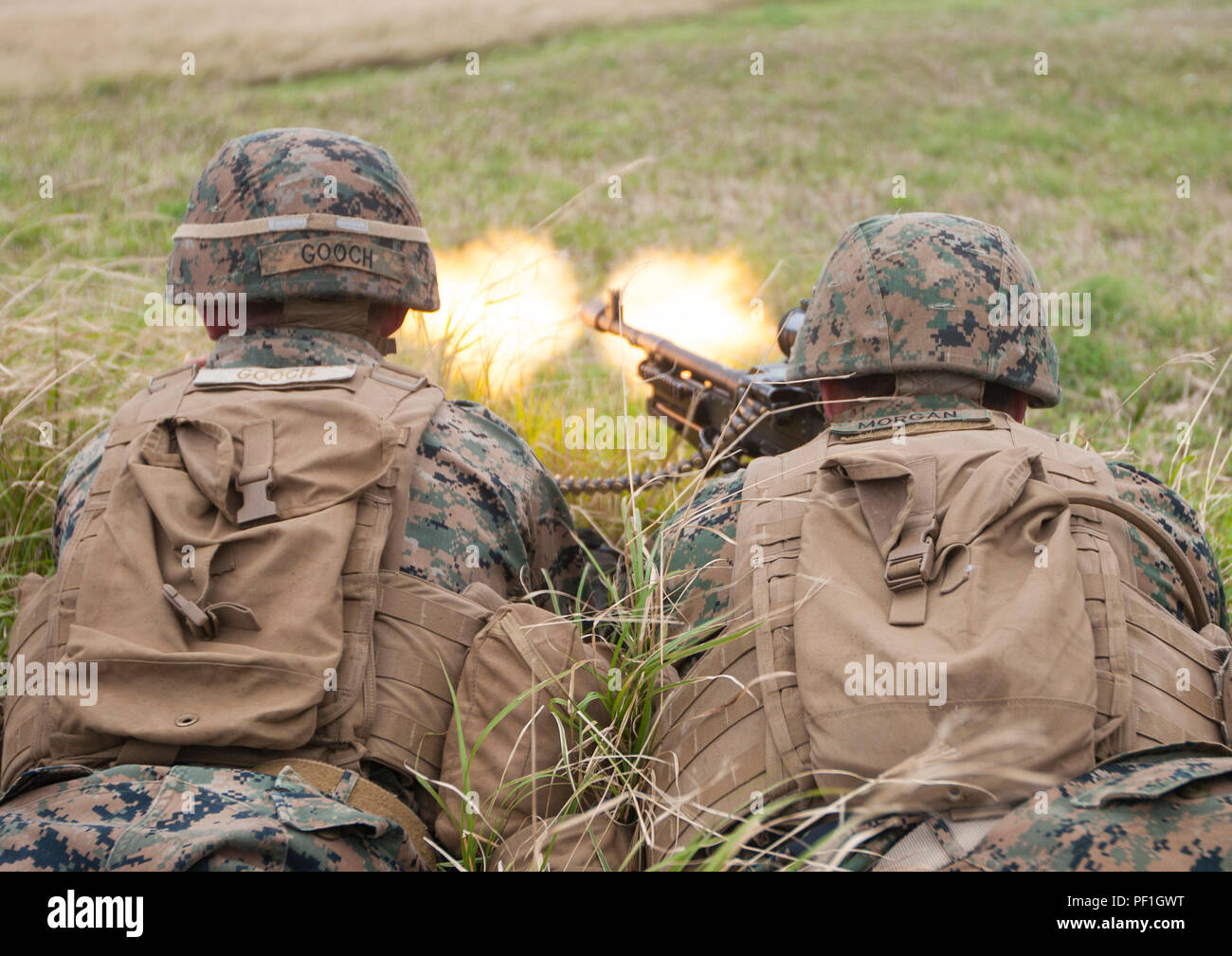 Cpl. Garret Gooch, left, and Lance Cpl. Taylor Morgan lay down ...