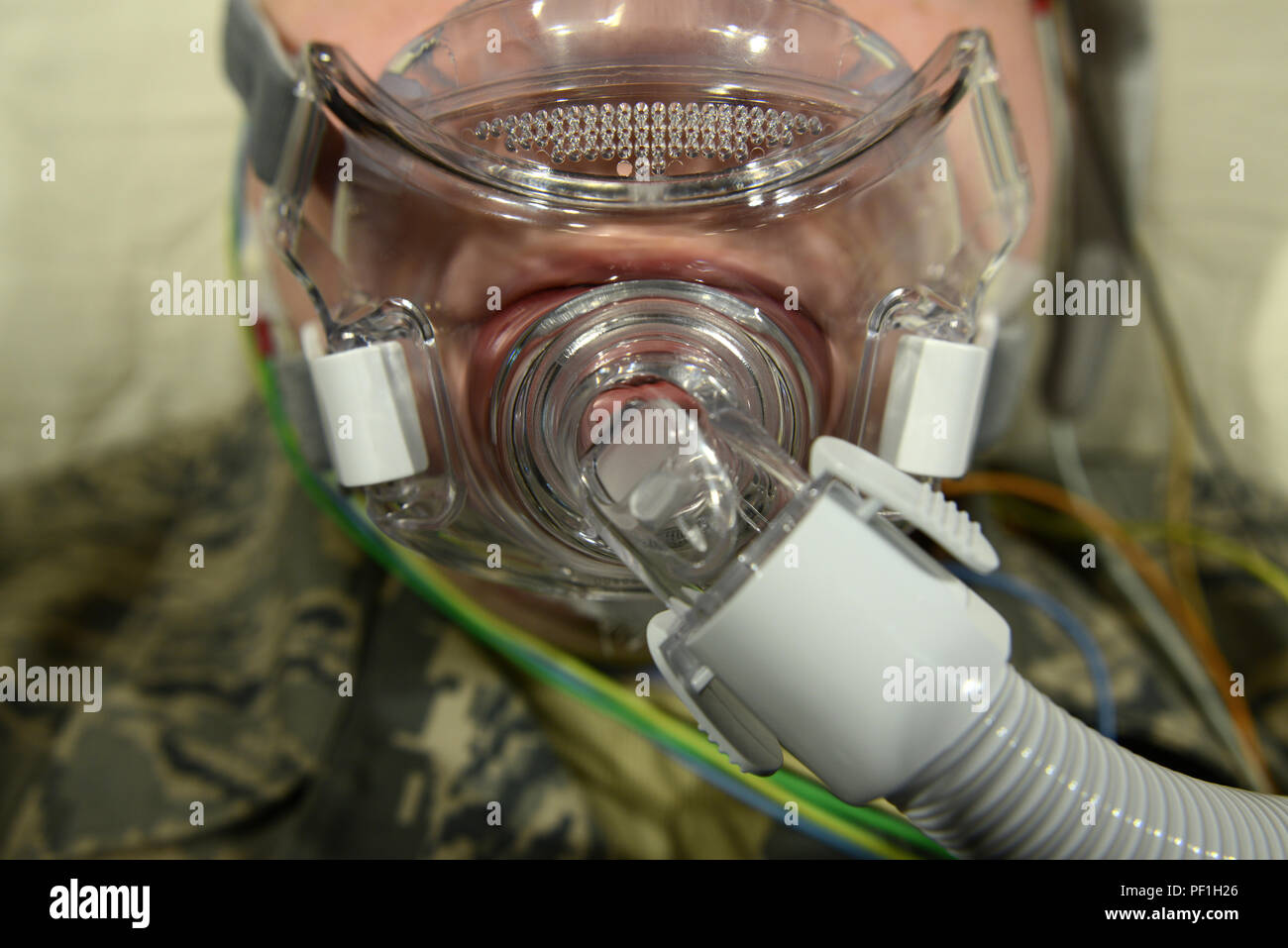 An Airman wears a continuous positive-air pressure mask in the 673d ...