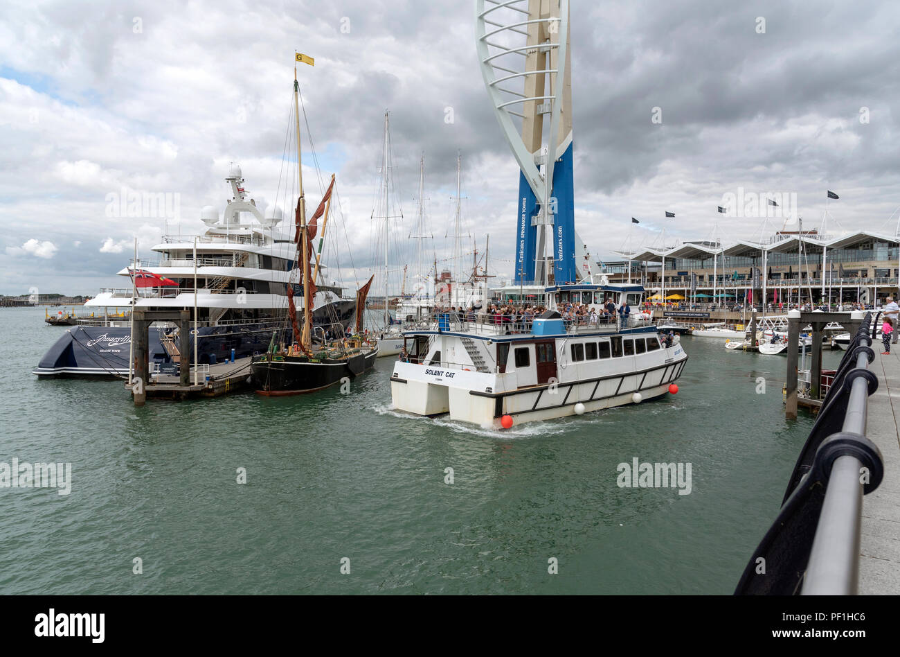 Super yacht Amaryllis and Alice a Thames sailing barge on the quay at ...
