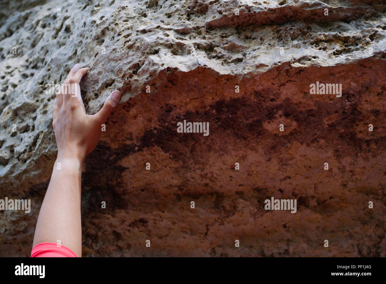 Image of man's hand clambering over rock Stock Photo - Alamy