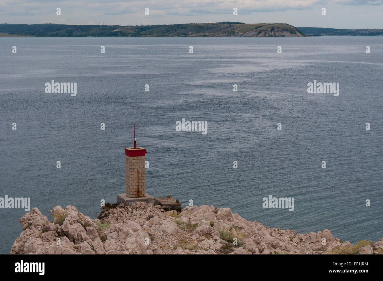 Croatia: stormy weather and the little red lighthouse on the cliff in ...