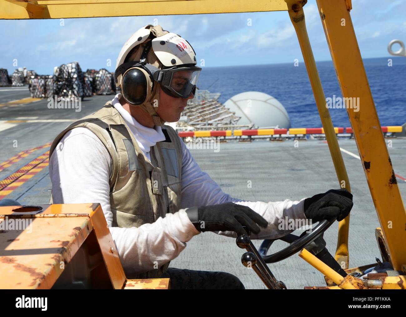Sailors operate a forklift on the flight deck of USS Bonhomme Richard ...