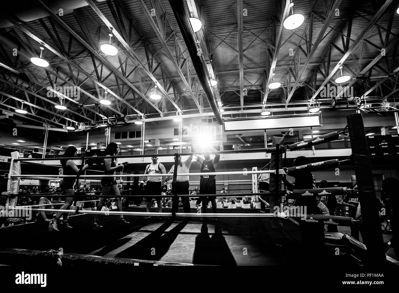 A referee declares a winner during a boxing tournament at Fort Bliss ...