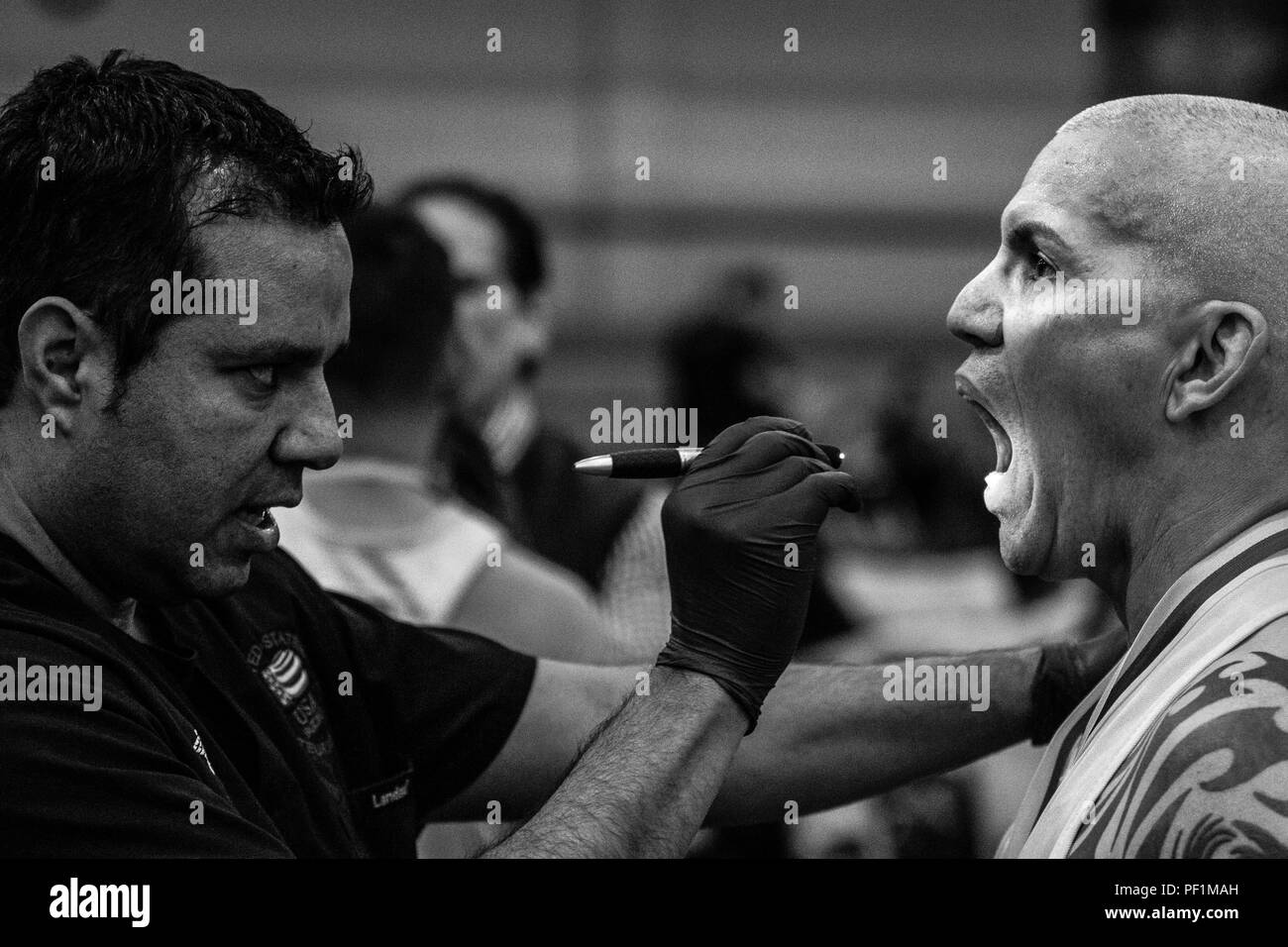A medic examines a boxer's mouth before he steps into the ring during a ...