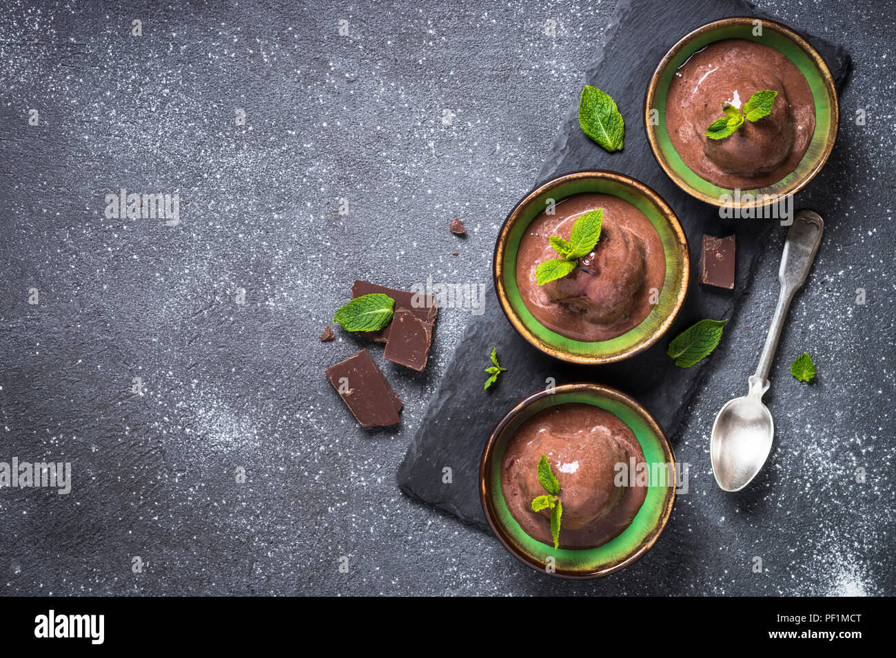 Chocolate ice cream top view on black Stock Photo - Alamy