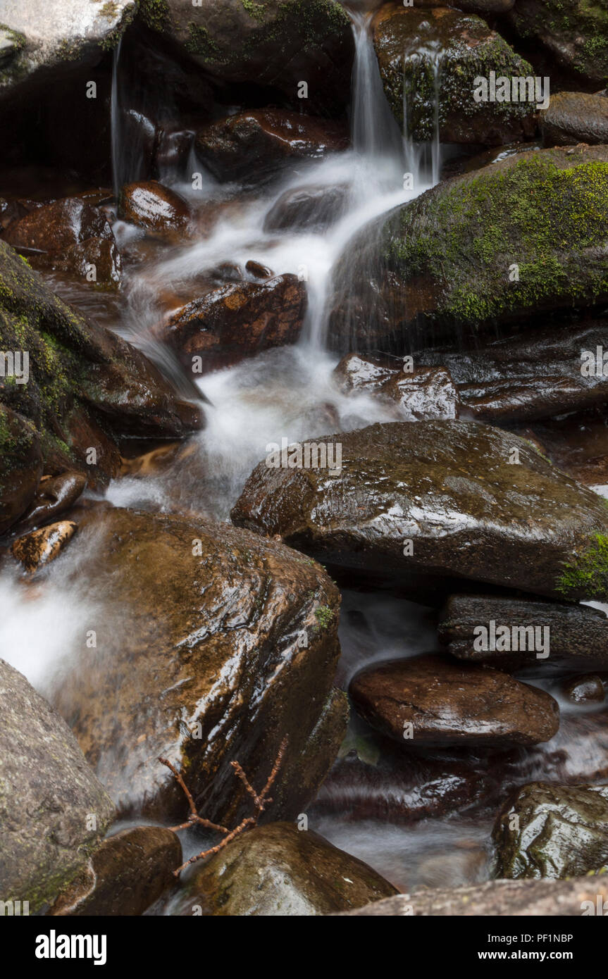 Moving waterfall over rocks Stock Photo - Alamy