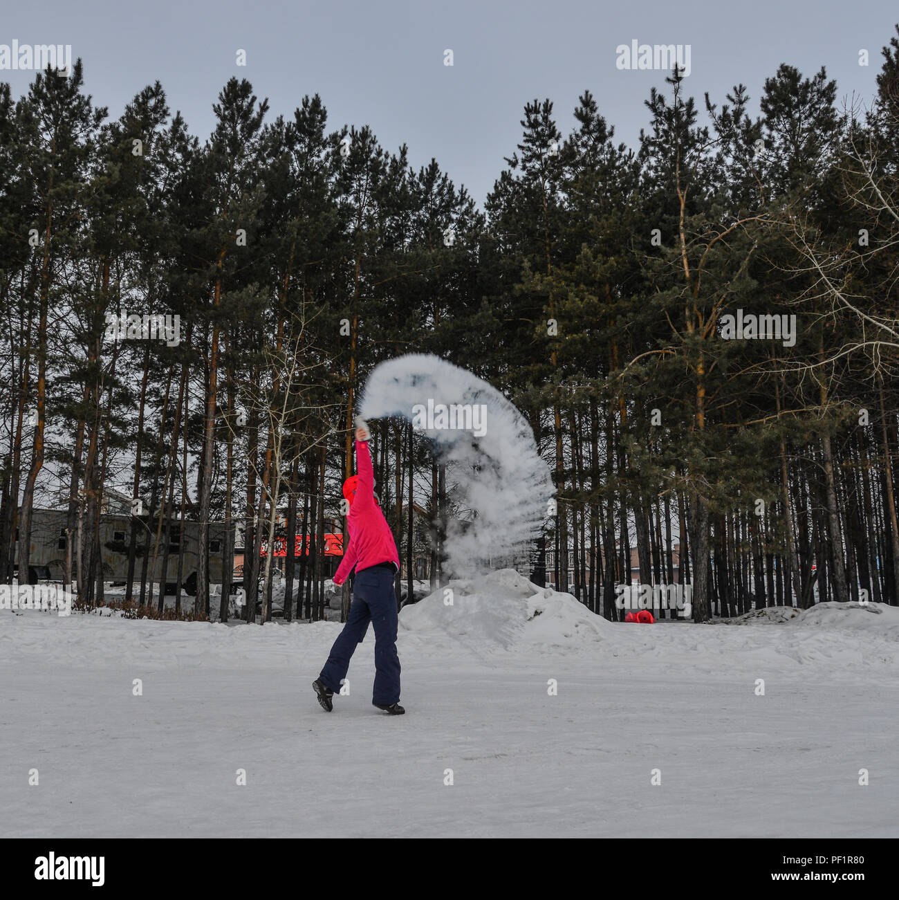 A woman throwing hot water at winter park in Harbin, China Stock Photo ...