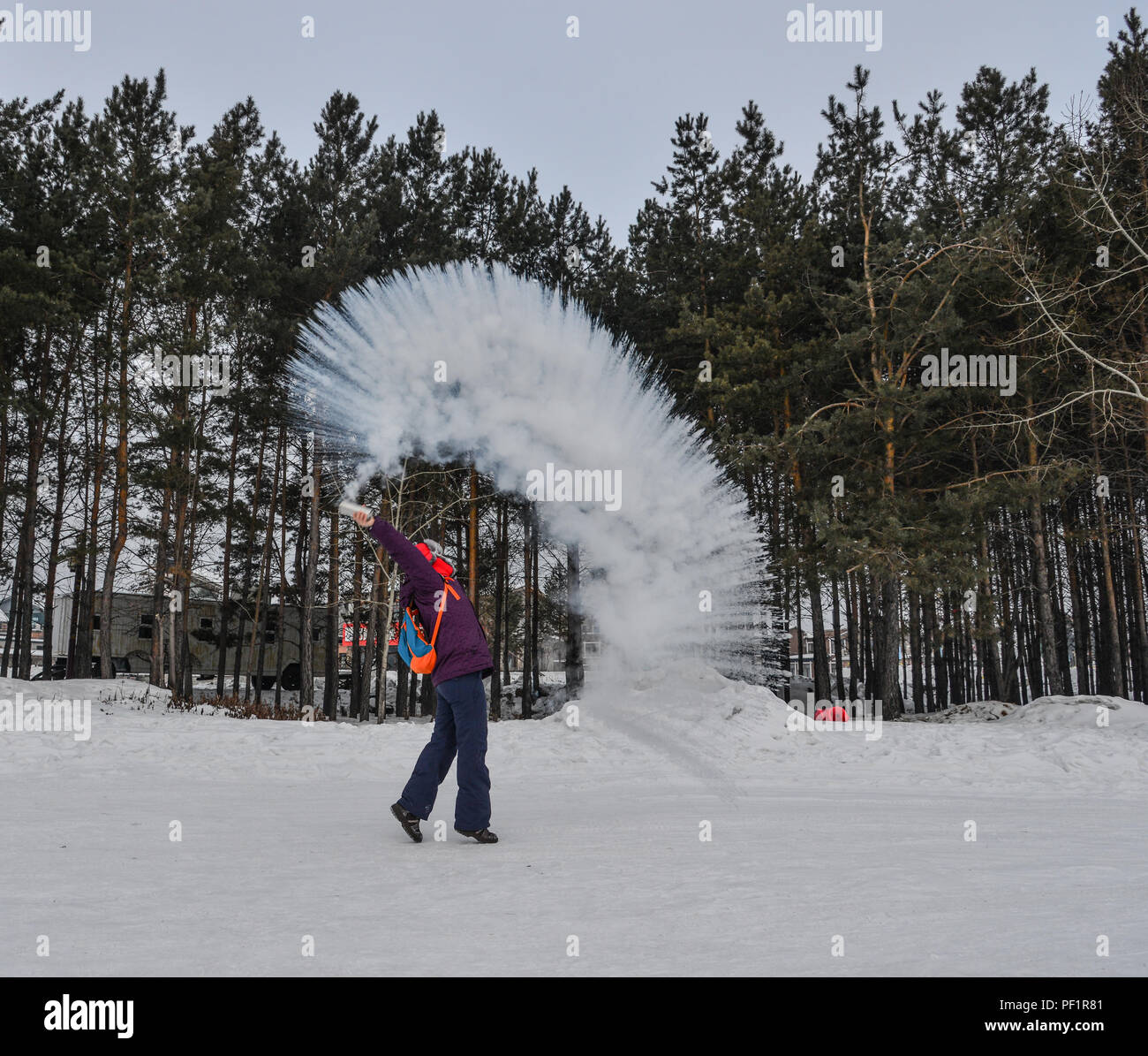 A woman throwing hot water at winter park in Harbin, China Stock Photo ...
