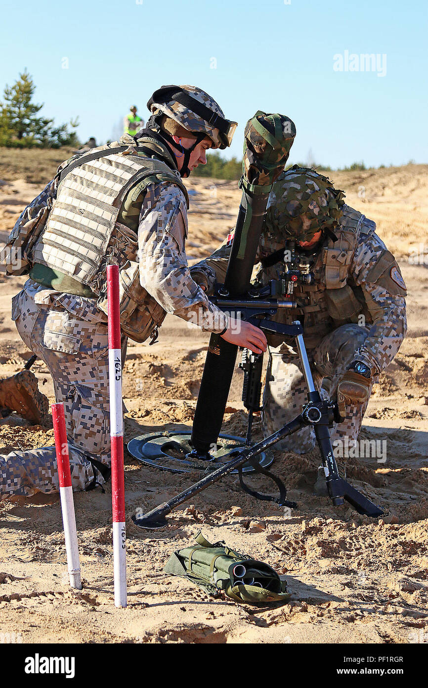 Latvian soldiers emplace an M252 mortar system during a multinational ...