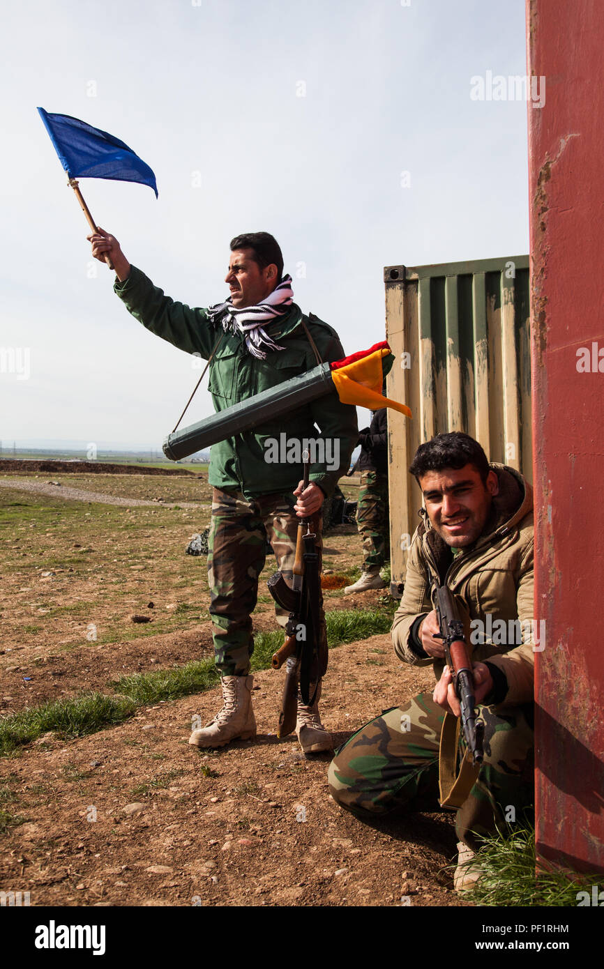 A Peshmerga soldier waves a signal flag during training at a base near ...
