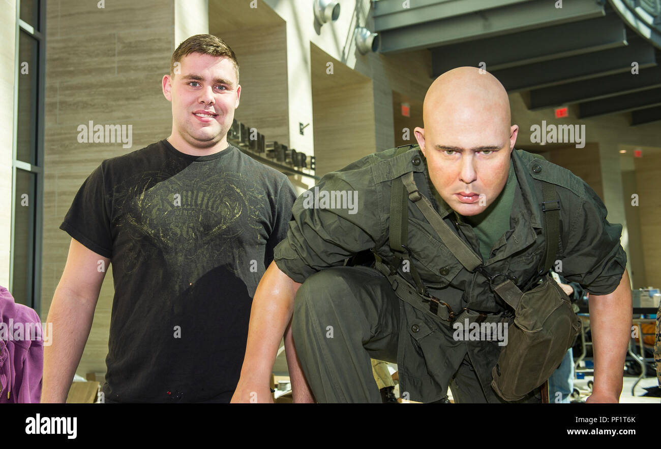 U.S. Marine Corps Cpl. Thomas Allen poses with the cast figure made in ...