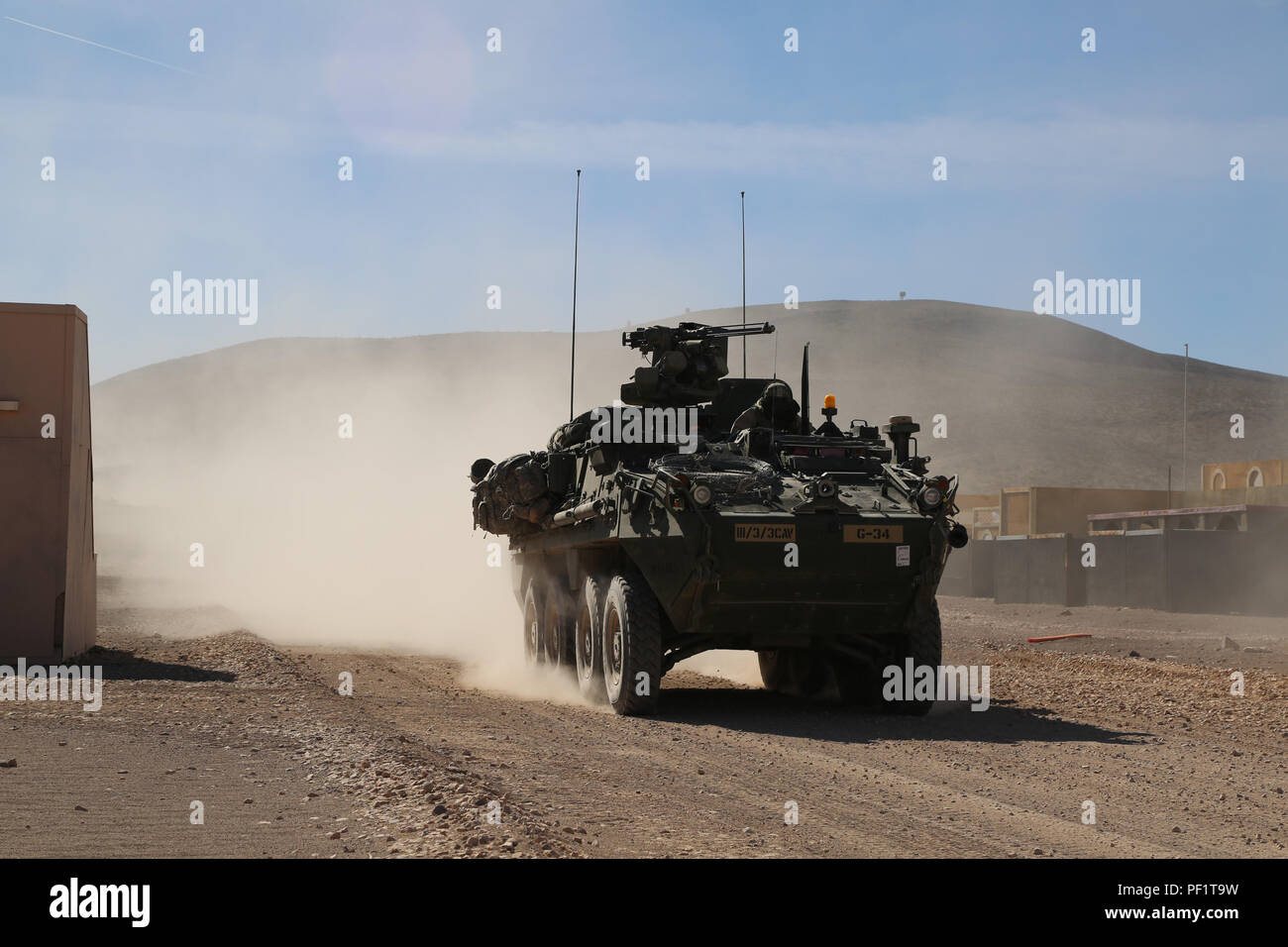 U.S. Army Soldier assigned to 3rd Cavalry Regiment maneuver a Stryker ...
