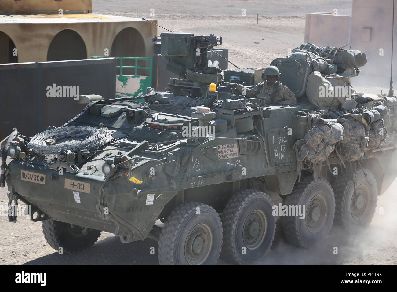U.S. Army Soldier assigned to 3rd Cavalry Regiment maneuver a Stryker ...