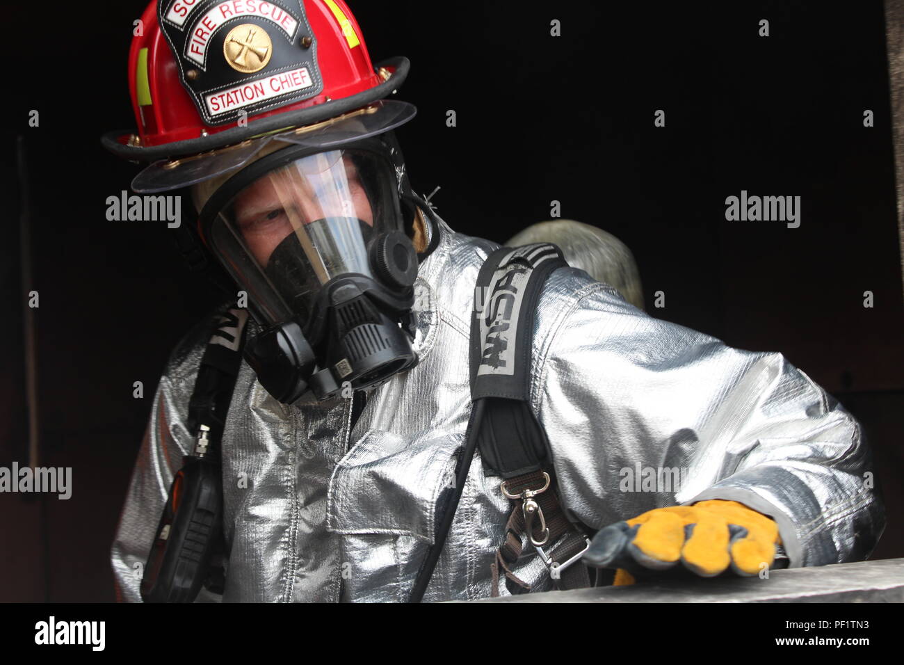A 612th Air Base Squadron firefighter, conducts an assessment of a fire ...