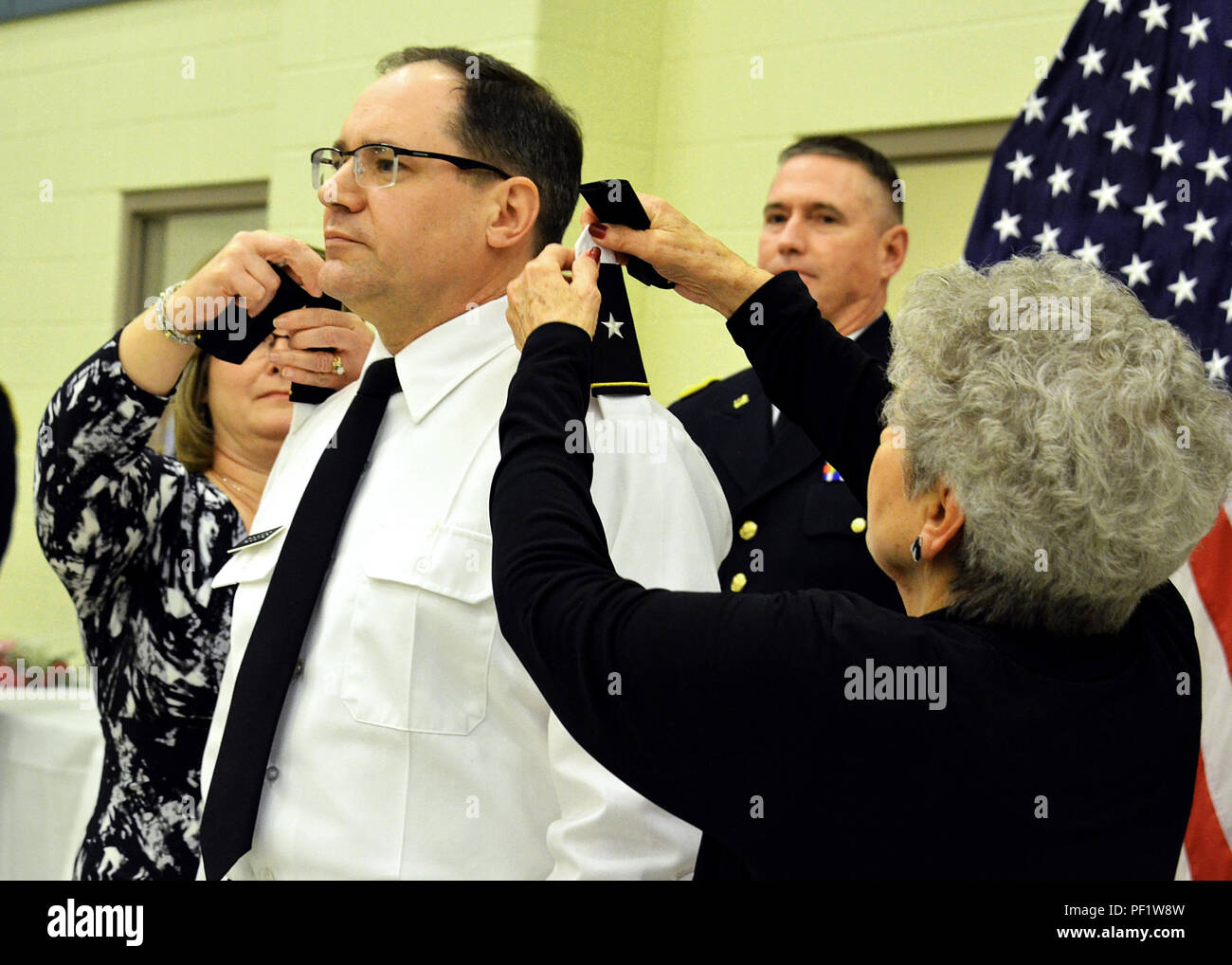 Michigan Army National Guard Soldier, Paul Rogers, receives symbols of ...