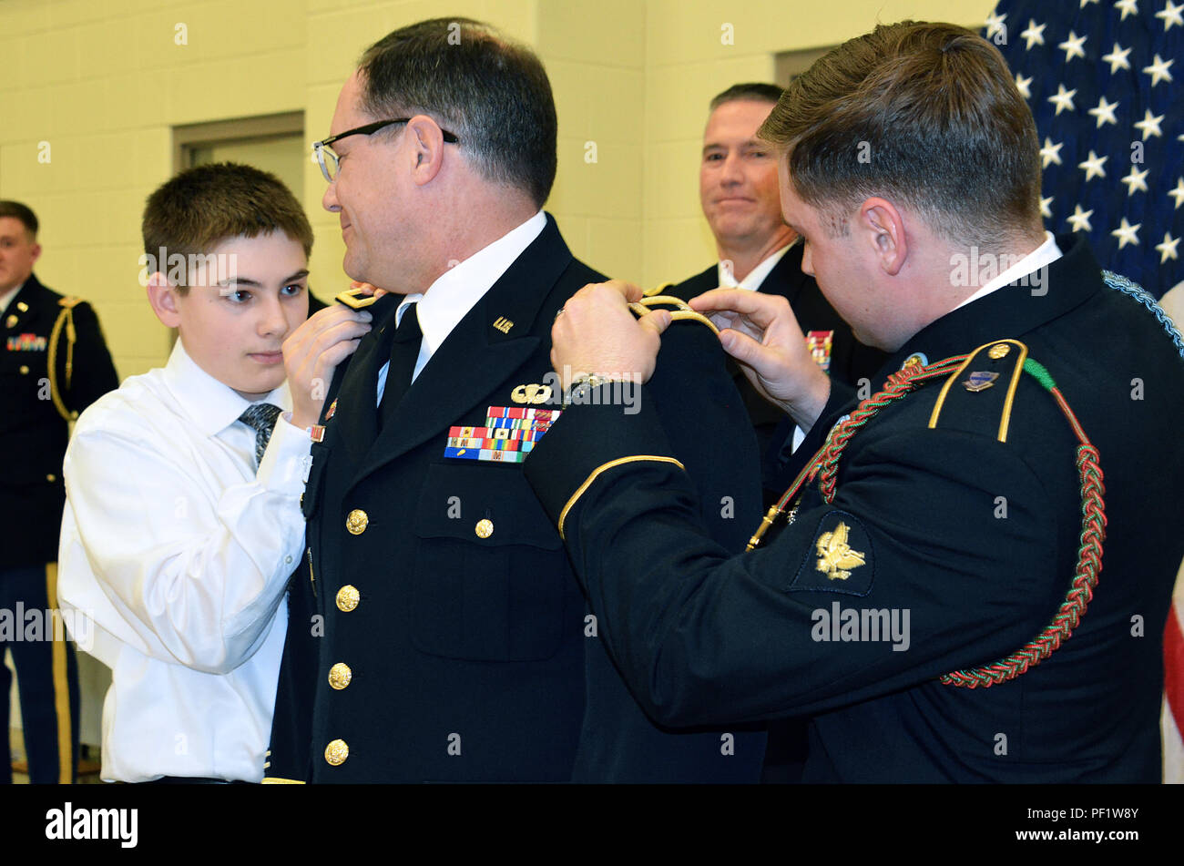 Michigan Army National Guard Soldier, Paul Rogers, receives symbols of ...