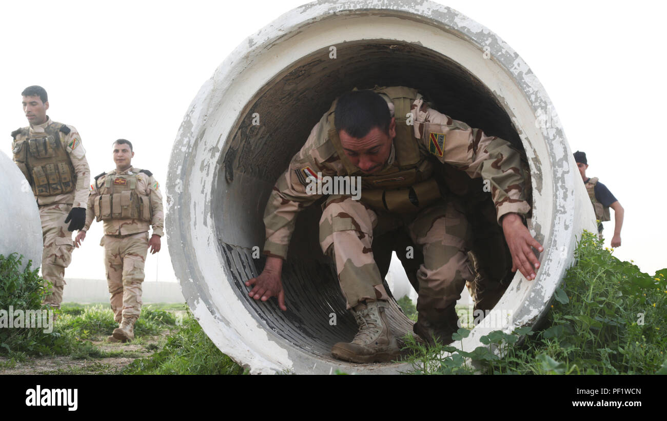 An Iraqi soldier with the Junior Leaders Course (JLC), crawls through a ...