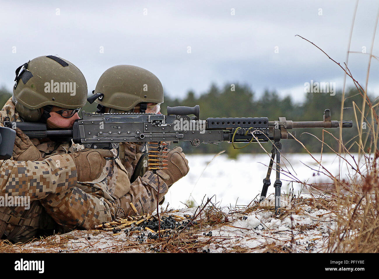 Latvian soldiers fire an M240B machine gun belonging to soldiers ...